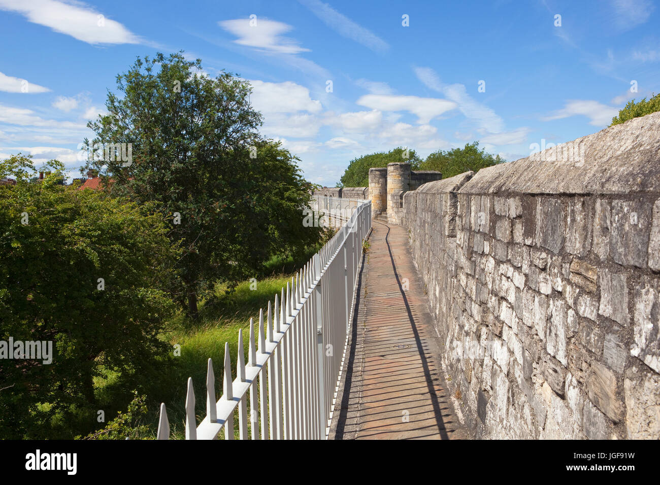 A section of the historic city walls of York under a blue summer sky ...