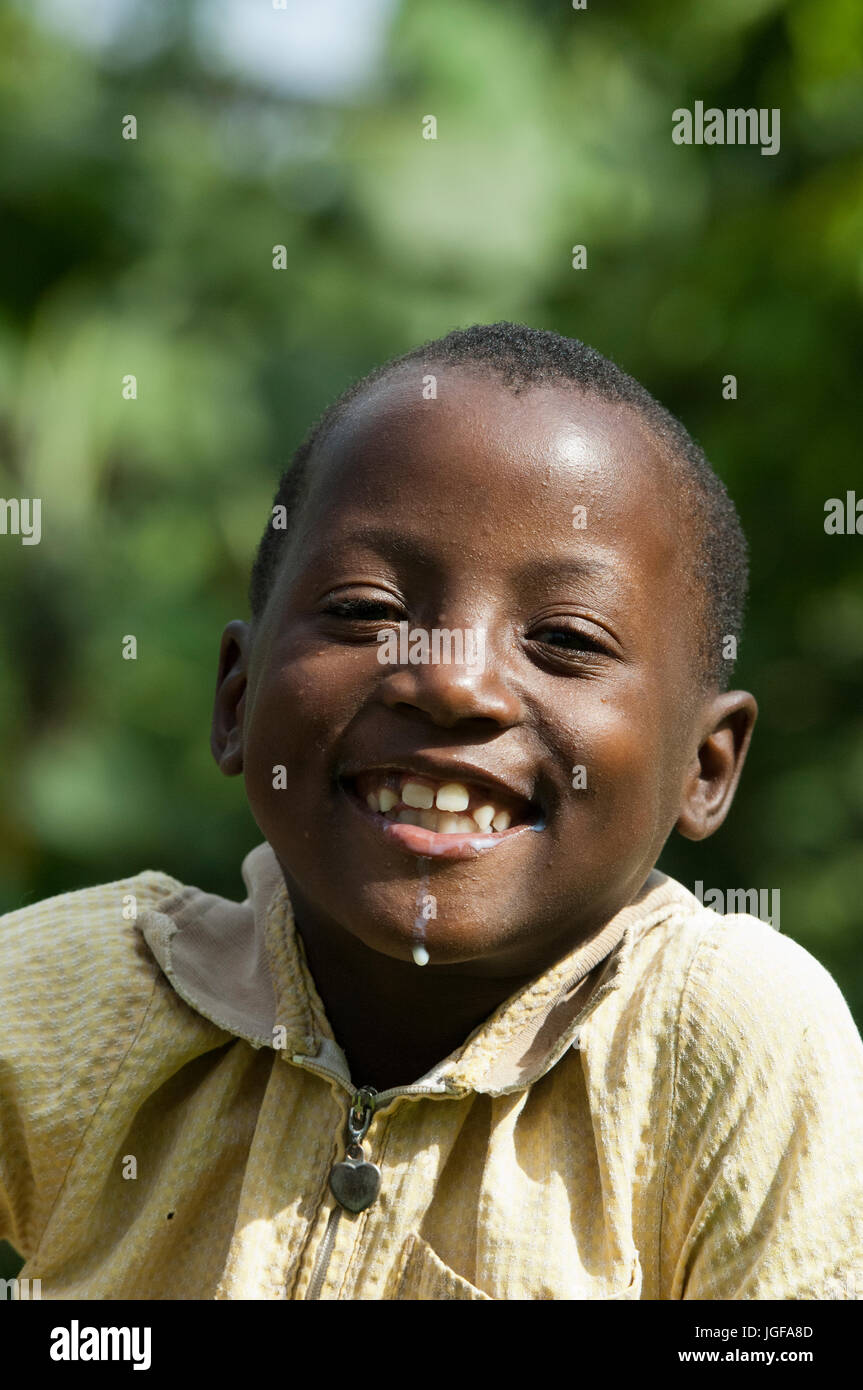 Happy, smiling Rwandan child, drinking milk Stock Photo - Alamy