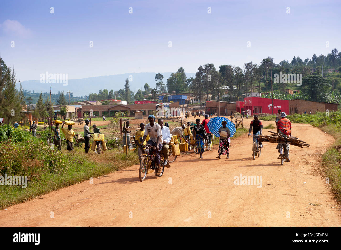 Busy roadside at the entrance to a village in Rwanda, with people ...