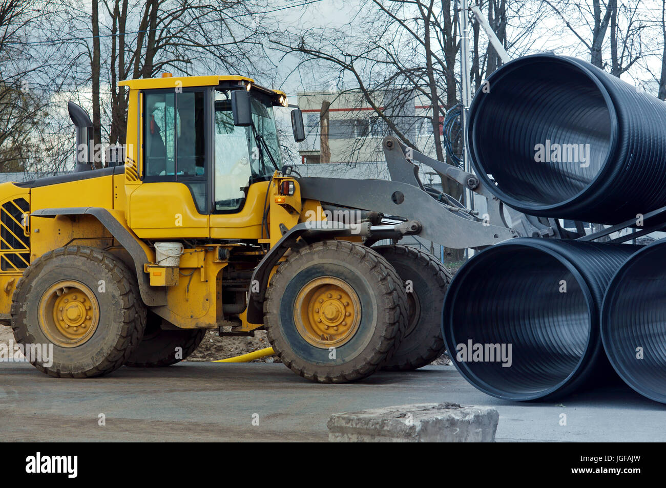 forklift distributes plastic pipes of large diameter Stock Photo - Alamy
