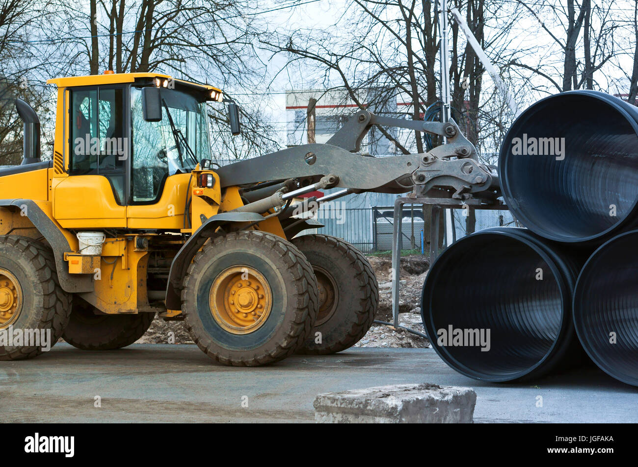 forklift distributes plastic pipes of large diameter Stock Photo - Alamy
