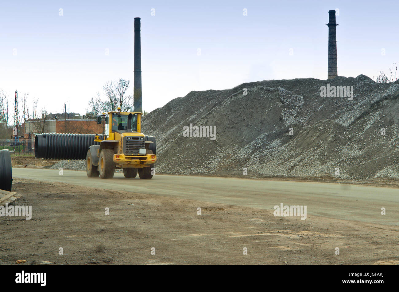 forklift distributes plastic pipes of large diameter Stock Photo - Alamy