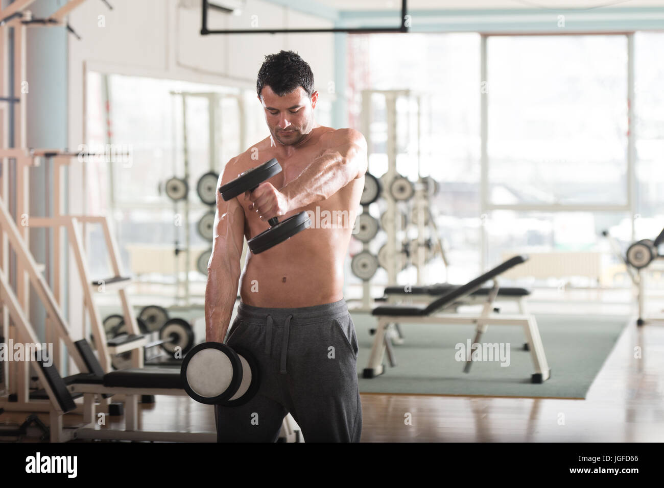 Athlete Working Out Shoulders In A Gym Stock Photo - Alamy