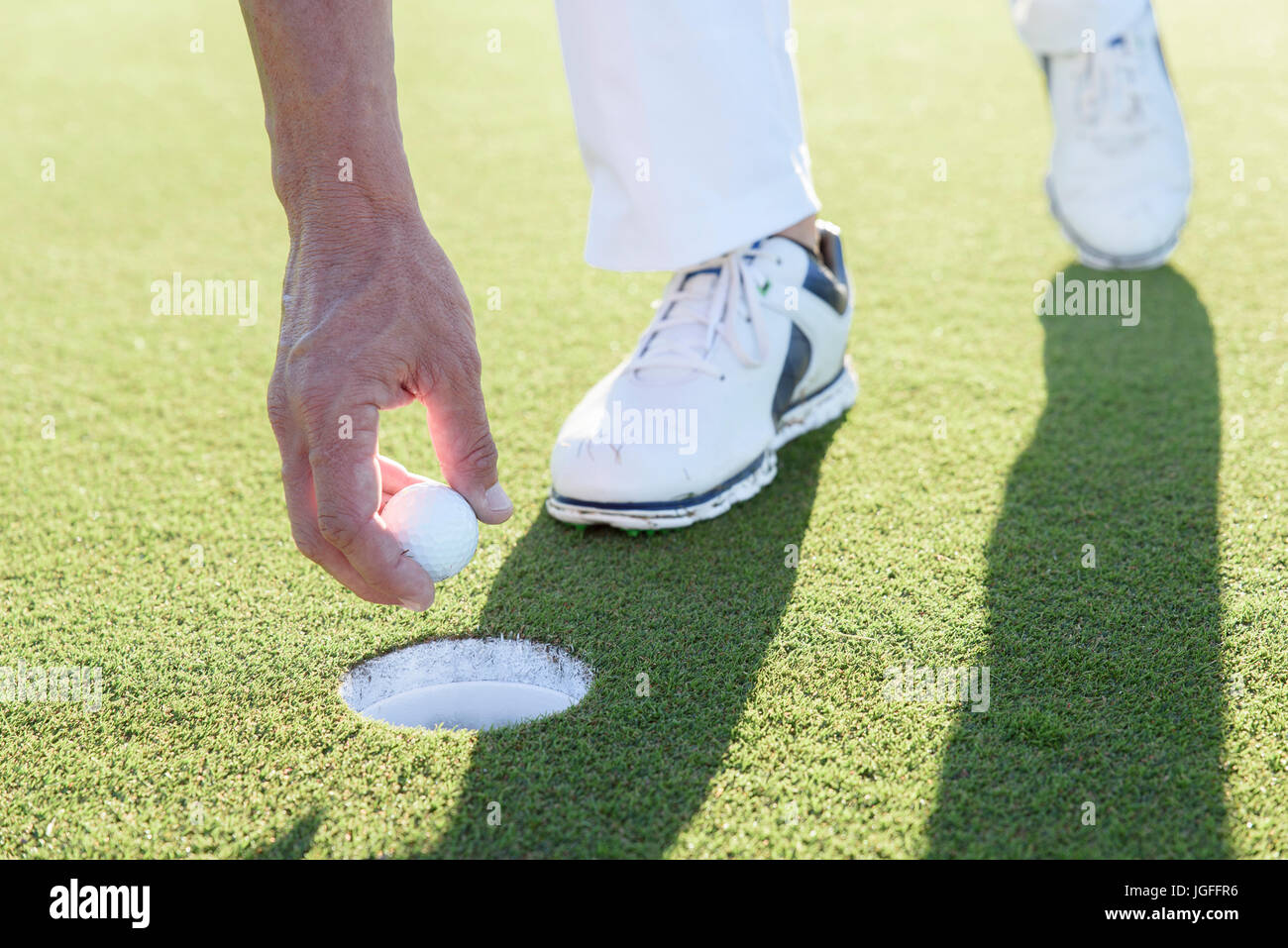 Retrieving golf ball from hole hi-res stock photography and images - Alamy