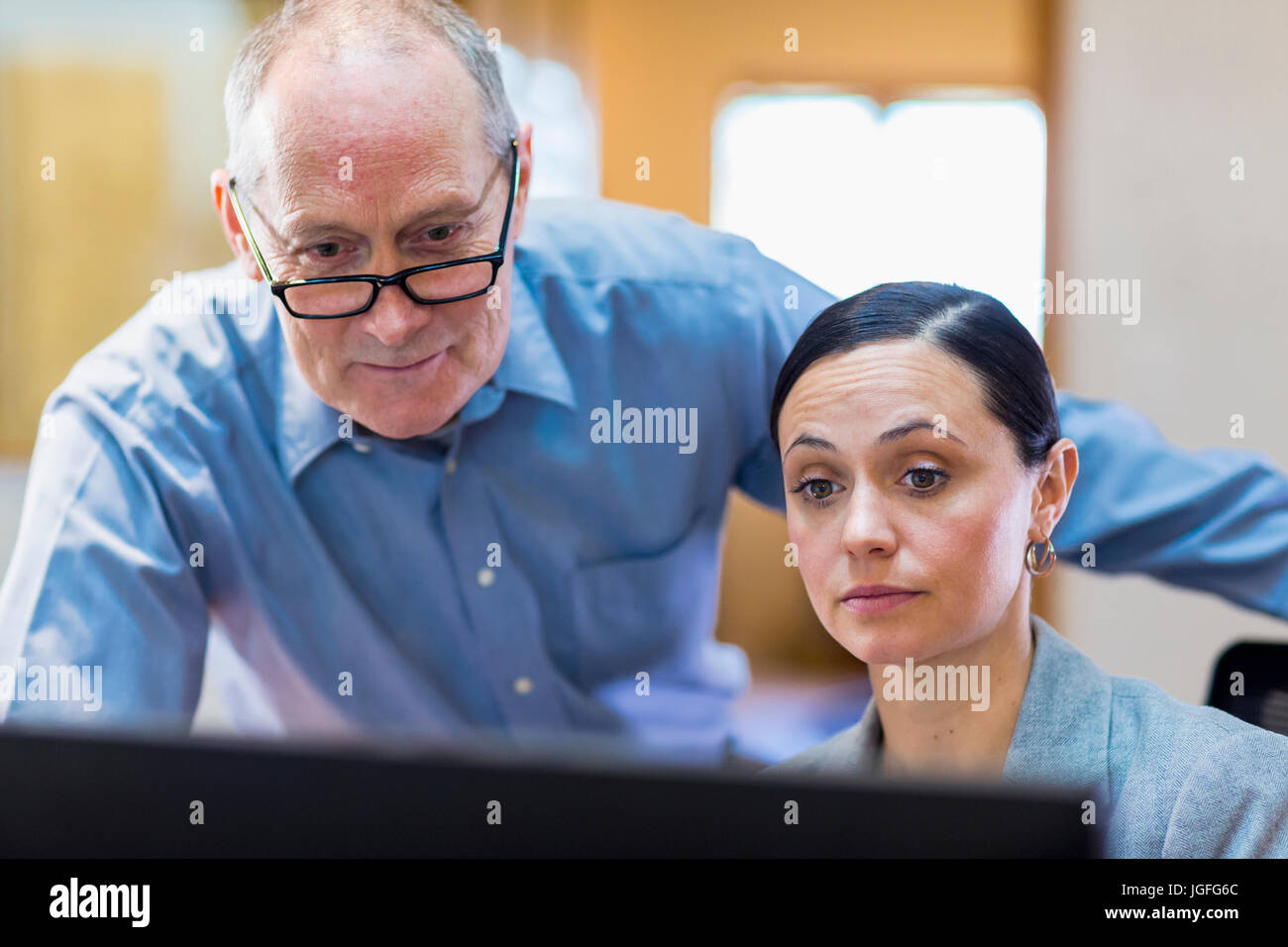 Caucasian business people reading computer Stock Photo - Alamy