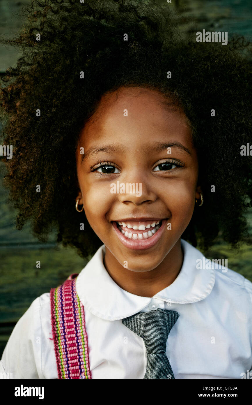 Portrait of smiling Mixed Race girl near wooden wall Stock Photo - Alamy