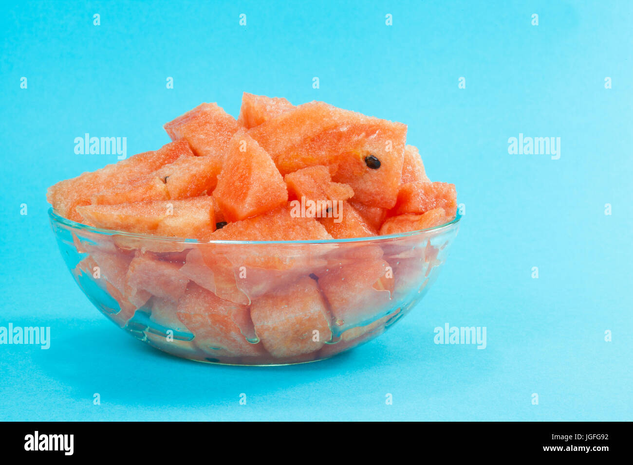 Watermelon chunks on blue background Stock Photo - Alamy