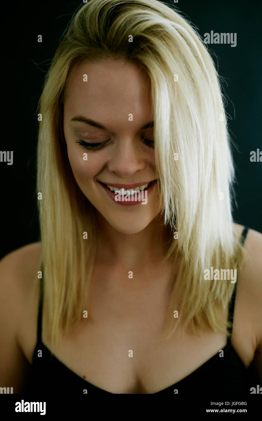 Smiling Caucasian woman looking down Stock Photo - Alamy Smiling Caucasian woman looking down Stock Photo - Alamy