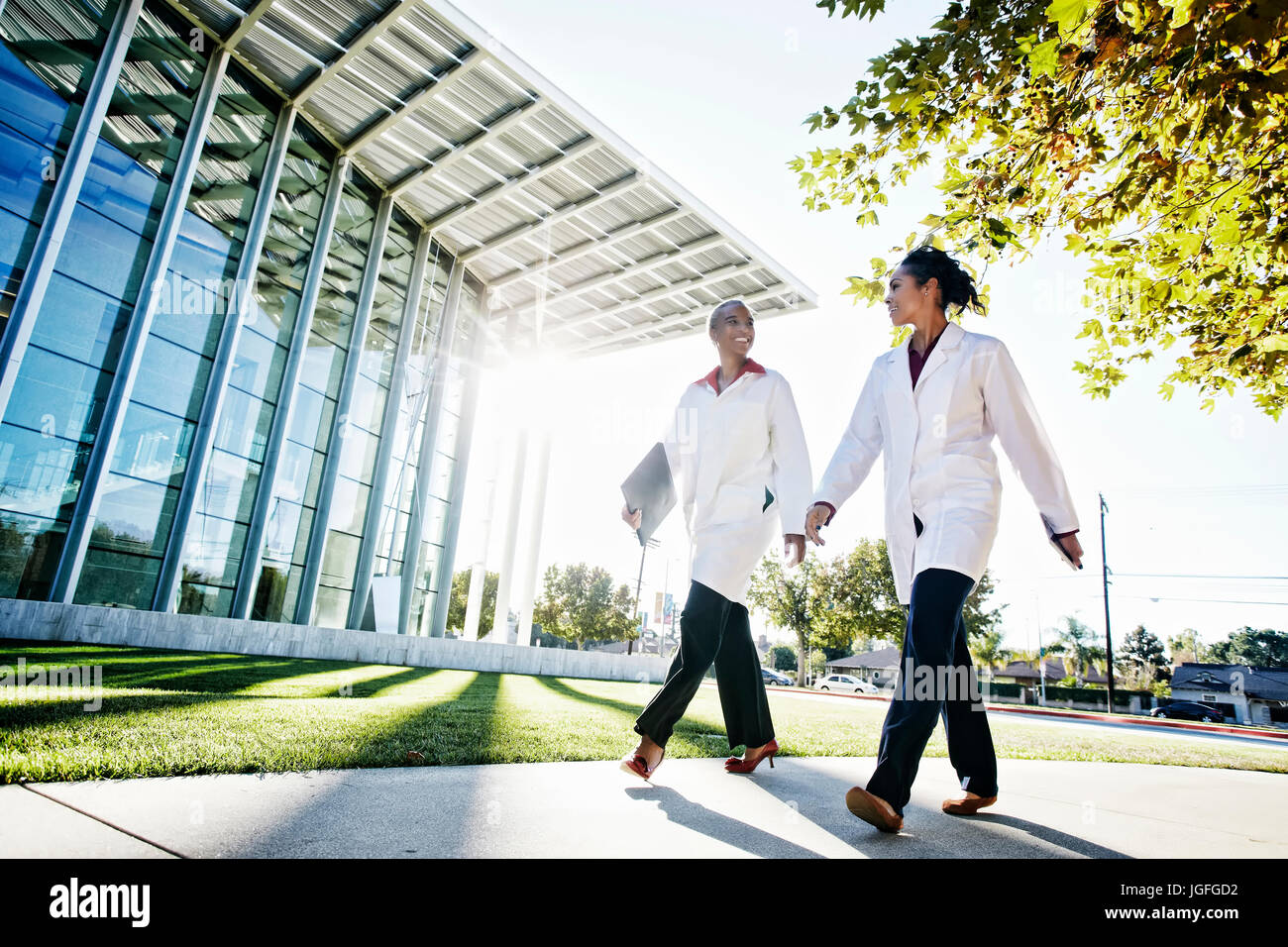 Doctors walking and talking outdoors at hospital Stock Photo - Alamy