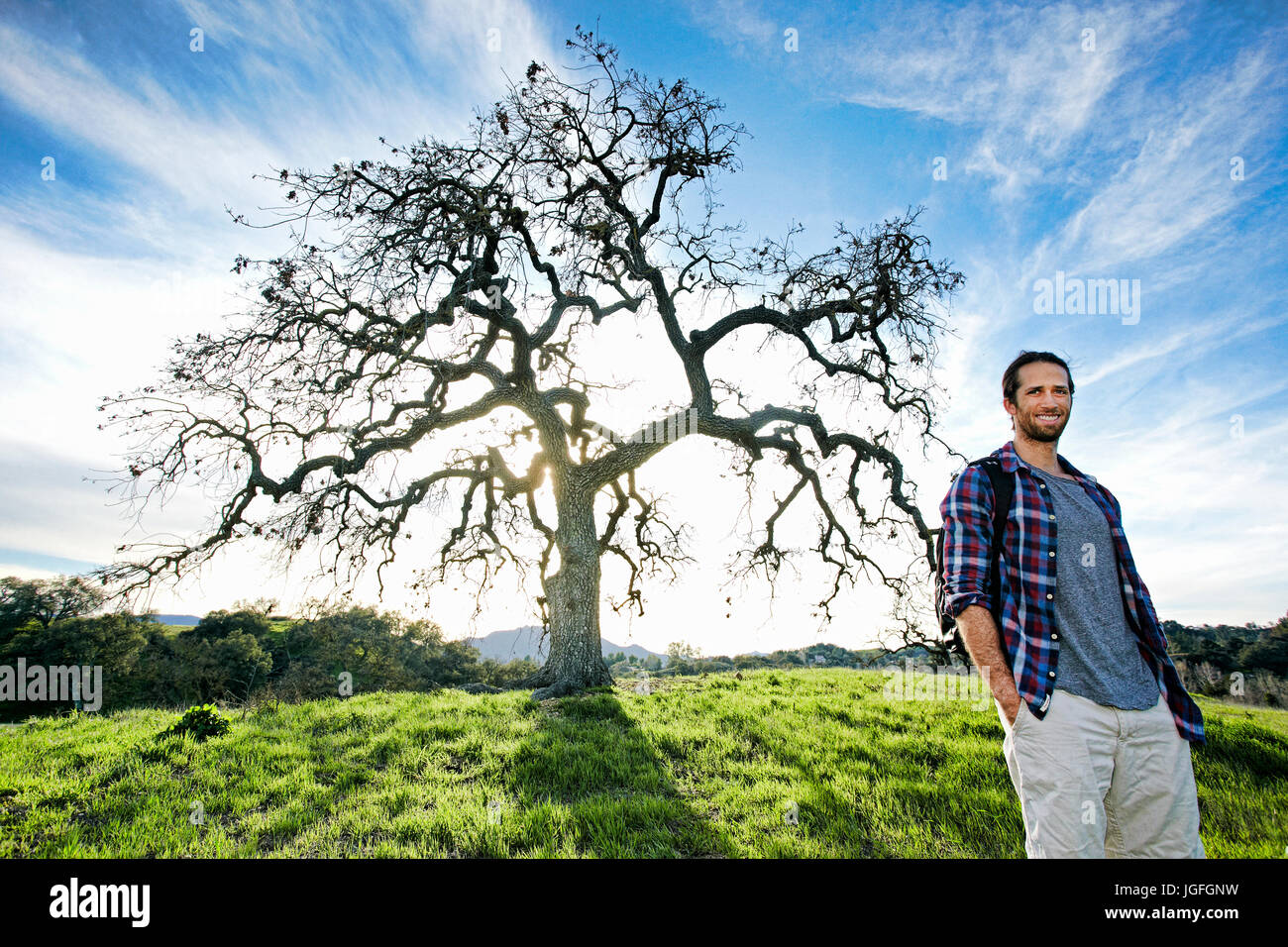 Hiker standing by tree hi-res stock photography and images - Alamy