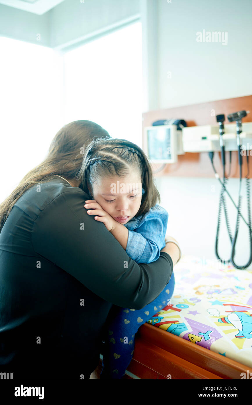 Hispanic mother hugging daughter with Down Syndrome Stock Photo - Alamy