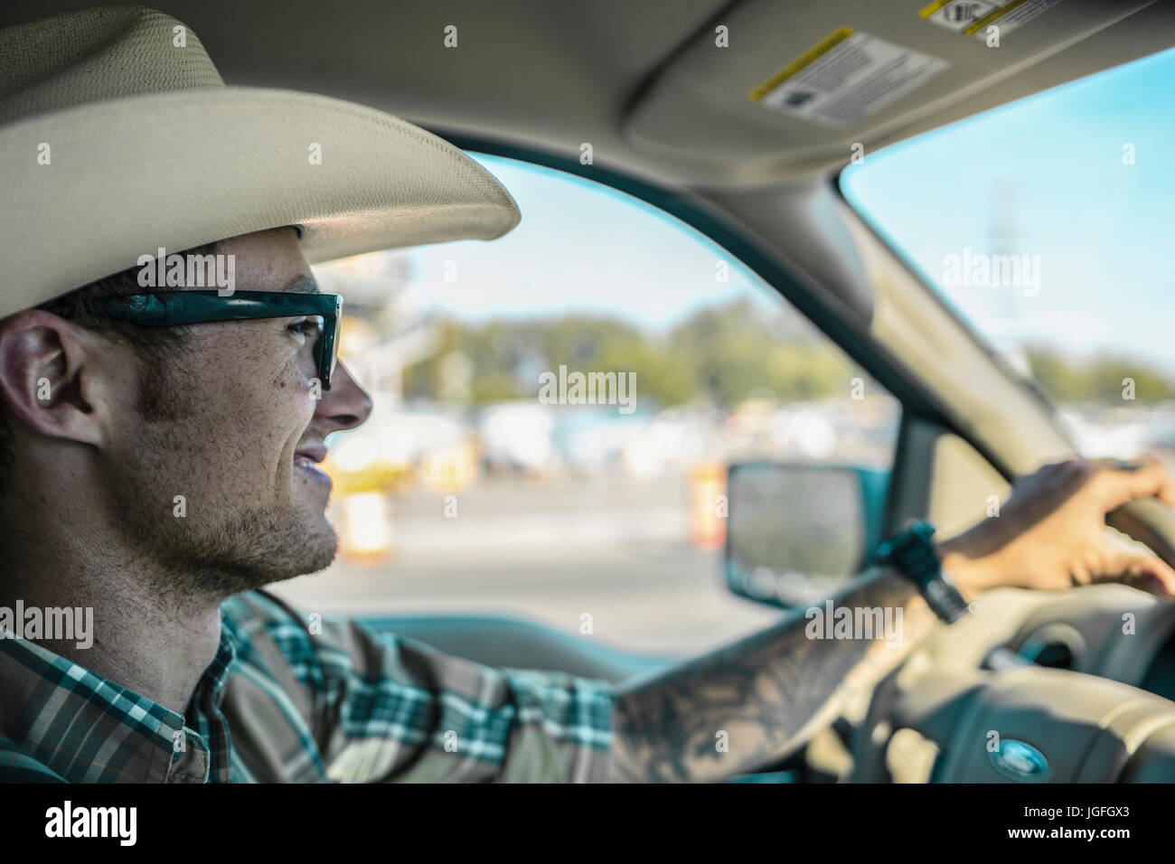 Caucasian man wearing cowboy hat driving car Stock Photo - Alamy
