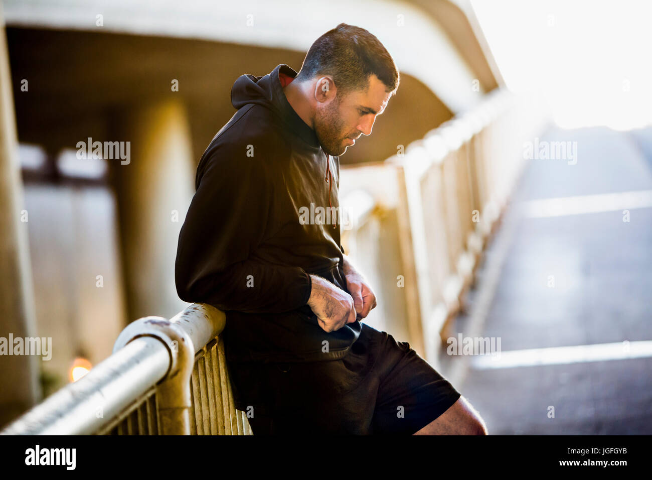 Caucasian man resting on railing Stock Photo - Alamy