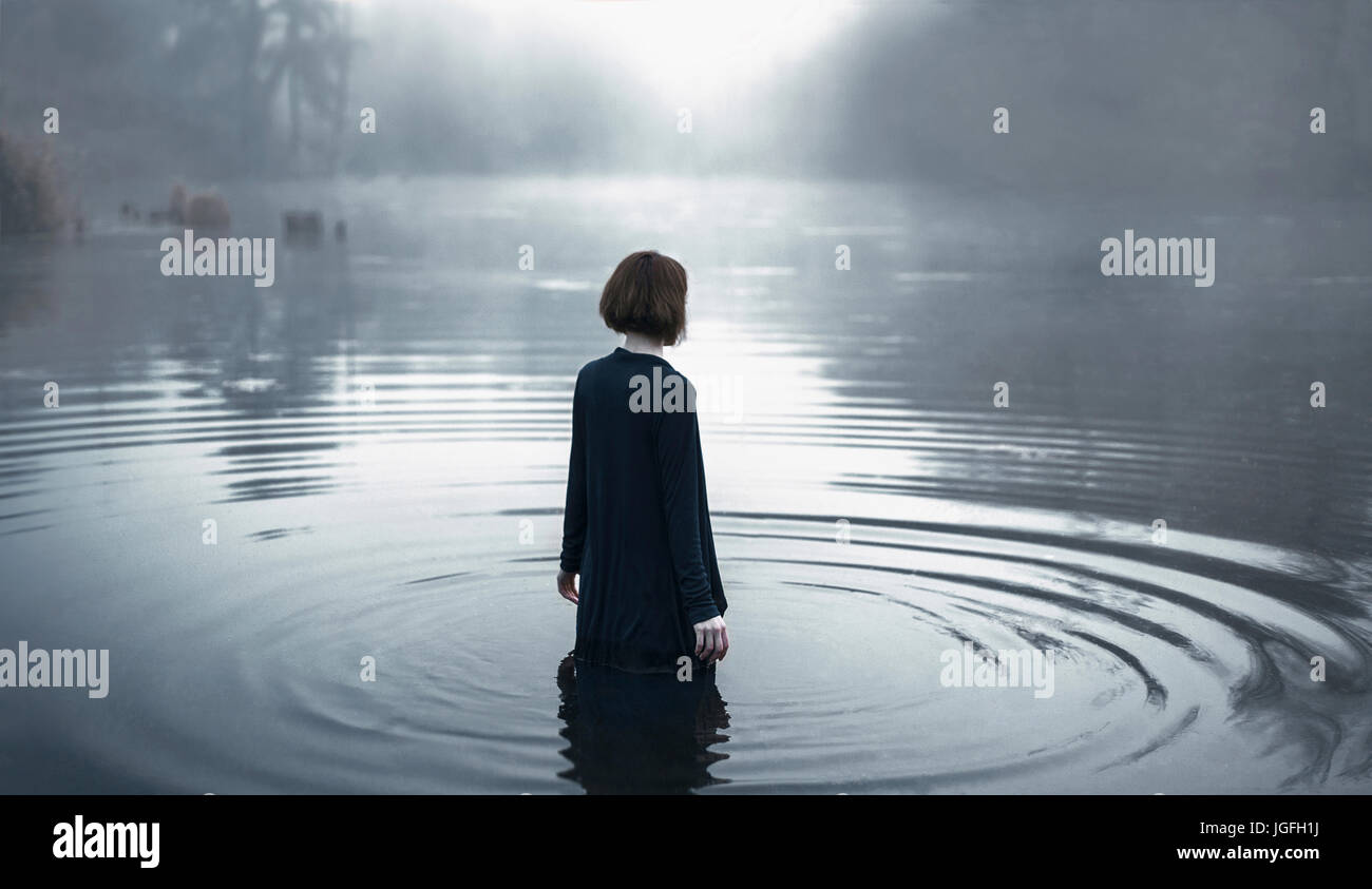 Woman wading in rippling river Stock Photo - Alamy