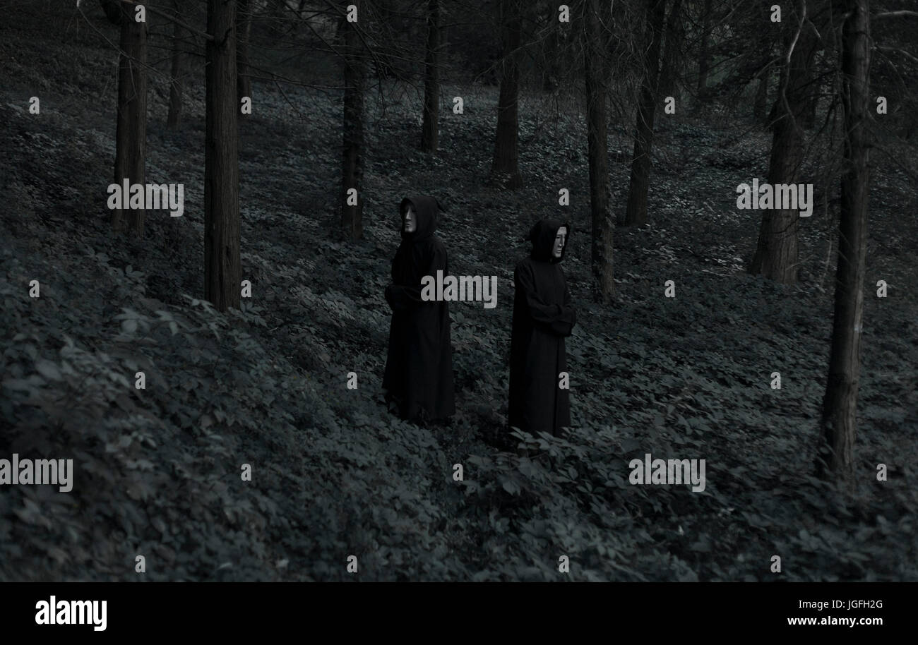People wearing black robes and white masks in forest Stock Photo - Alamy