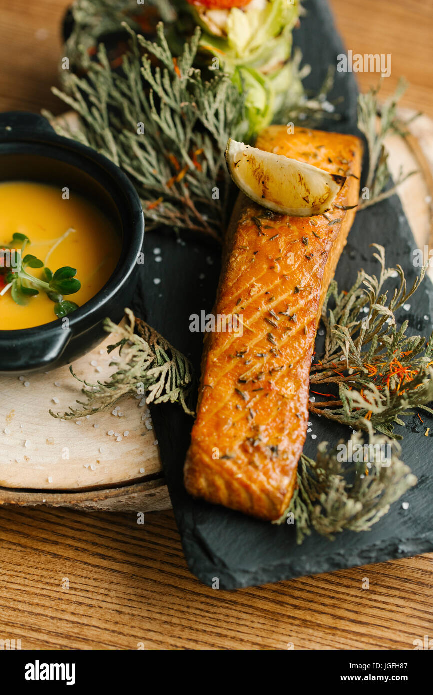 Fish with melted butter and lemon slice Stock Photo - Alamy