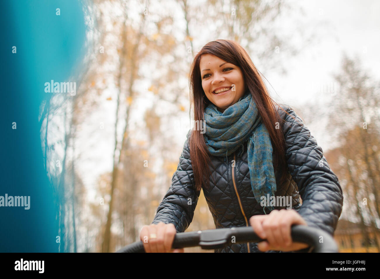 Smiling Middle Eastern woman pushing stroller Stock Photo - Alamy