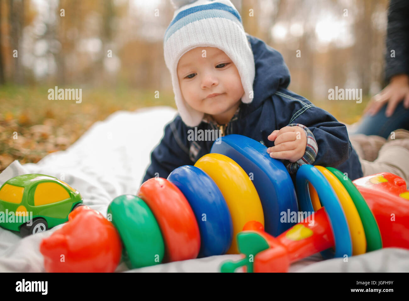 Middle Eastern baby boy playing with toys in park Stock Photo - Alamy