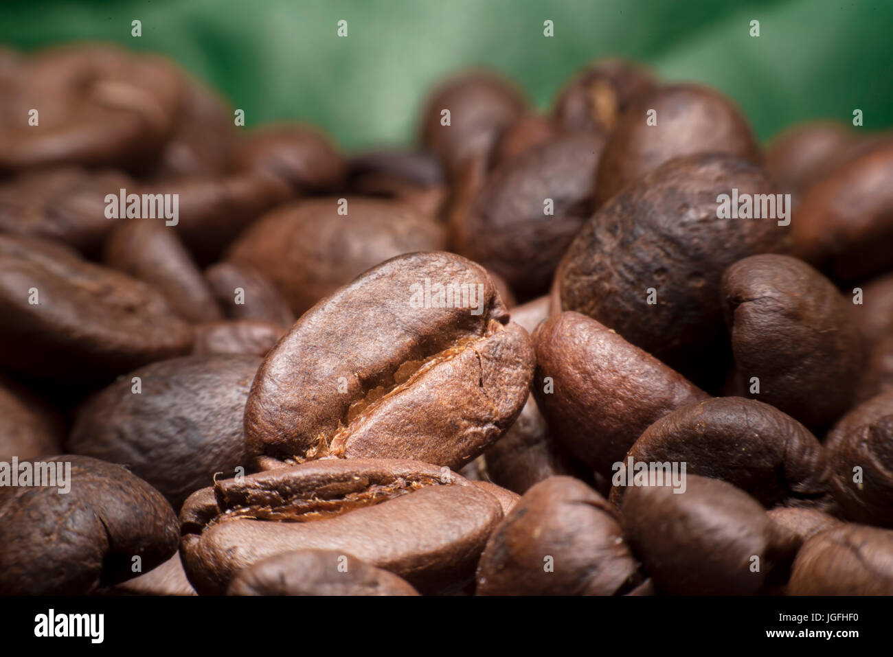 close up coffee bean green background Stock Photo - Alamy