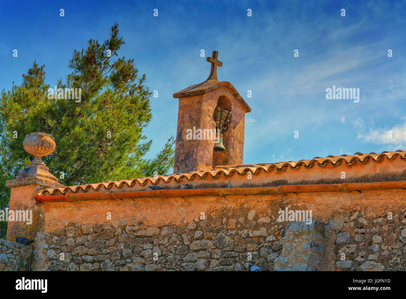 Church tower with bell in Spanish style against a blue sky Stock Photo ...