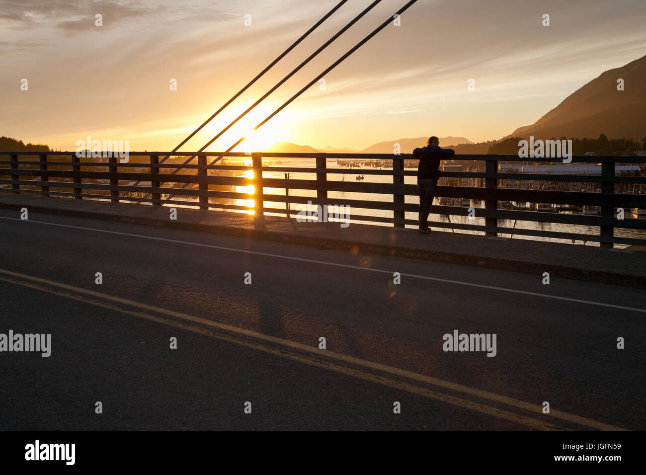 Person on bridge looks over sea hi-res stock photography and images - Alamy