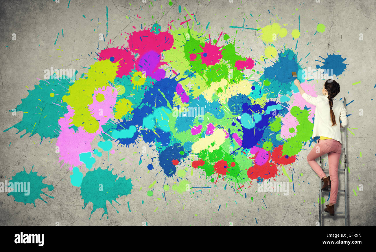 Girl paint wall in colors Stock Photo - Alamy