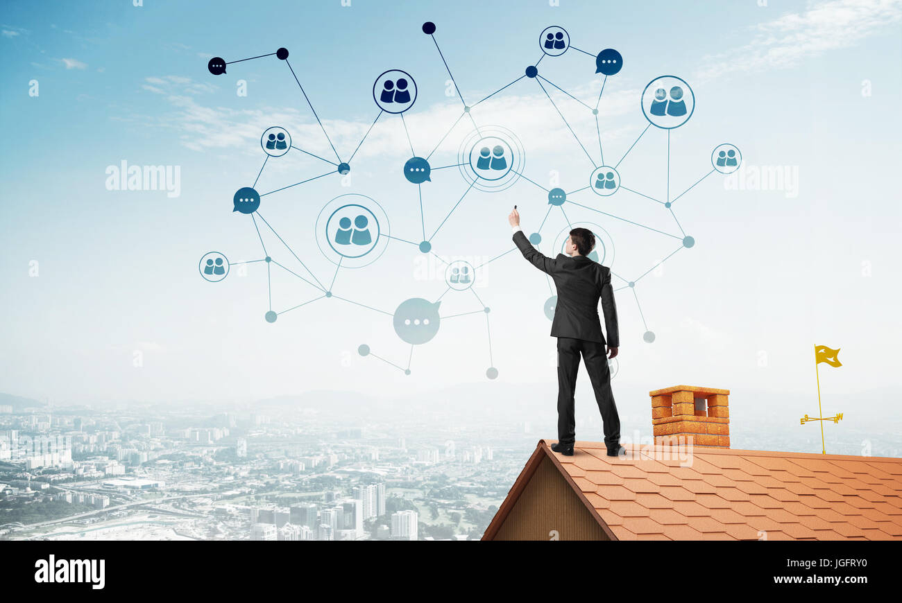 Businessman on house roof presenting networking and connection concept ...