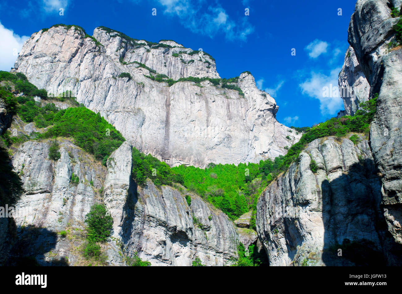 A rock cliff against a blue sky in the early morning at Fangdong Scenic ...