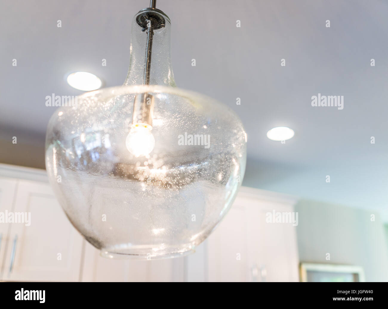 Macro closeup of transparent light modern fixture hanging from ceiling ...