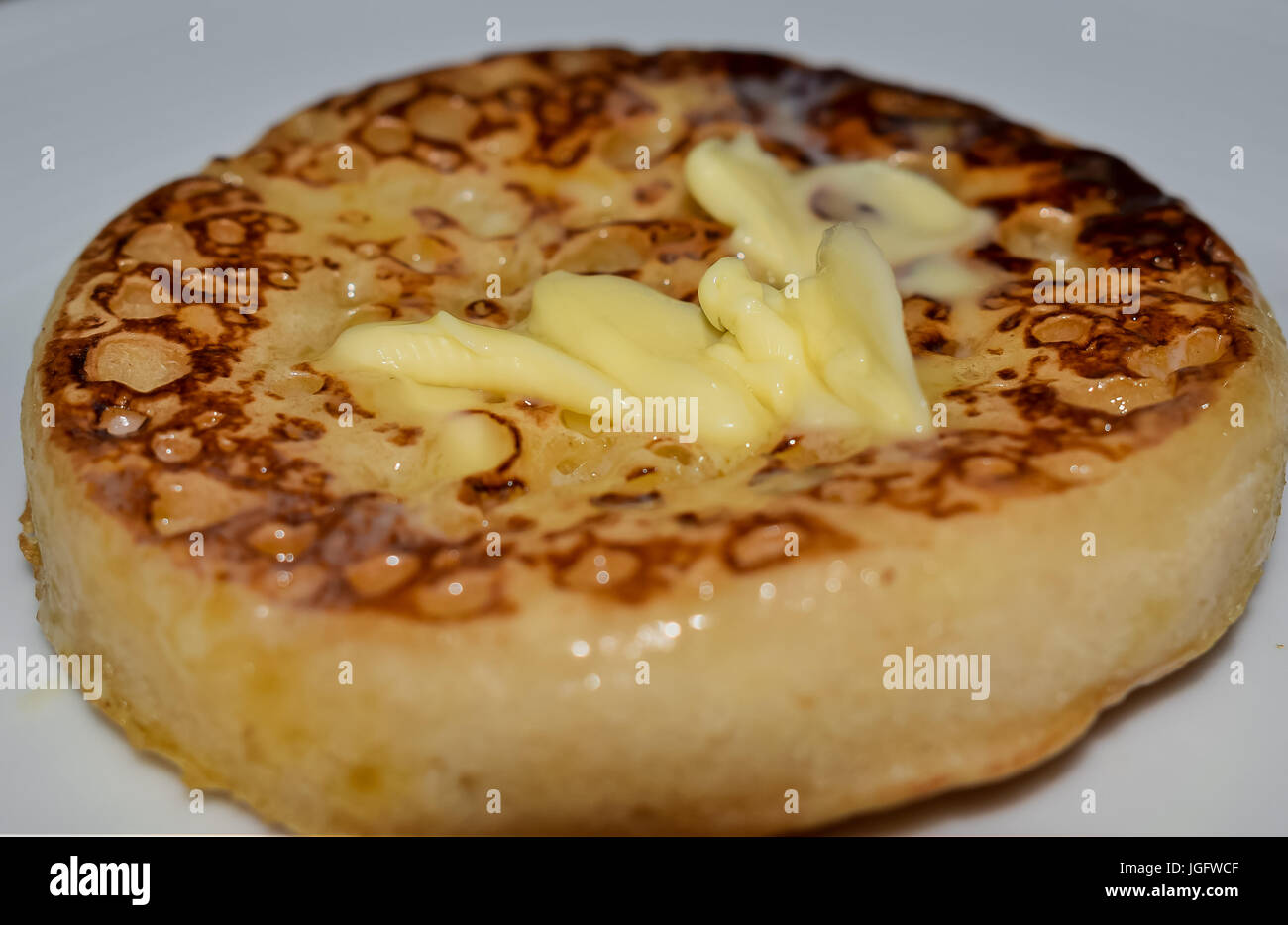 crumpet dripping with butter Stock Photo - Alamy