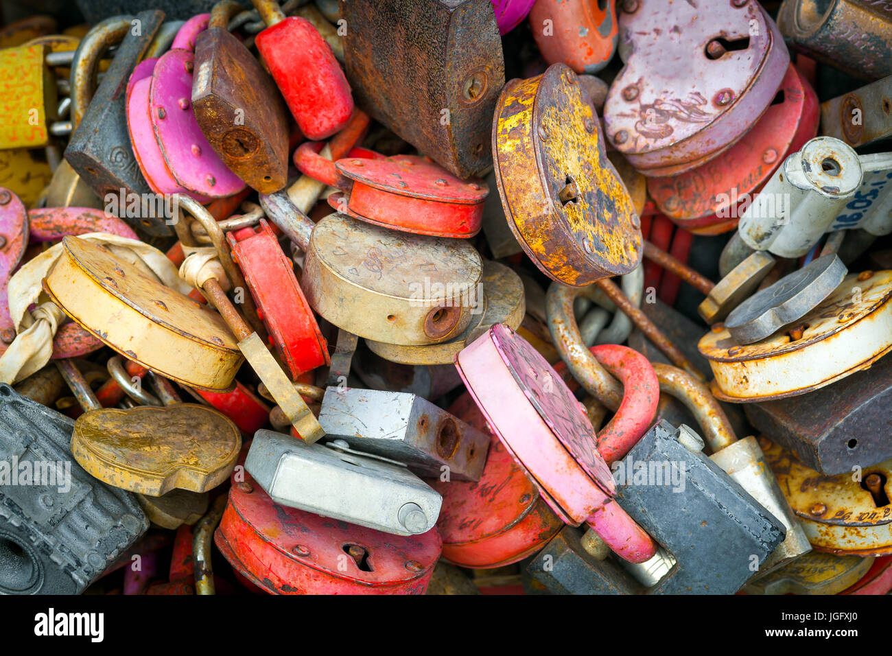 There are a lot of old padlocks. Different colors and shapes. Rusted ...