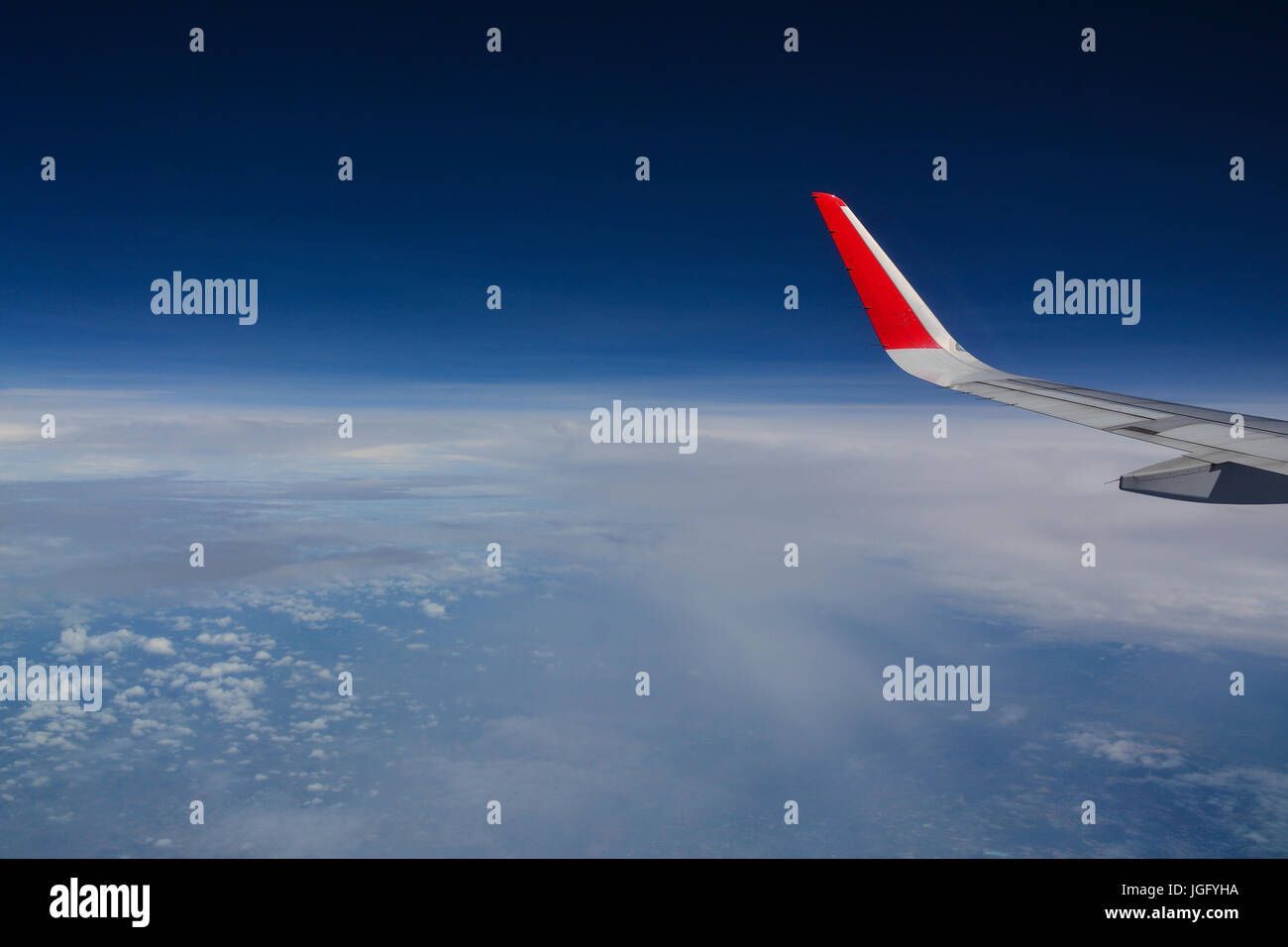 Looking through window aircraft during flight. Flying over the blue sky ...