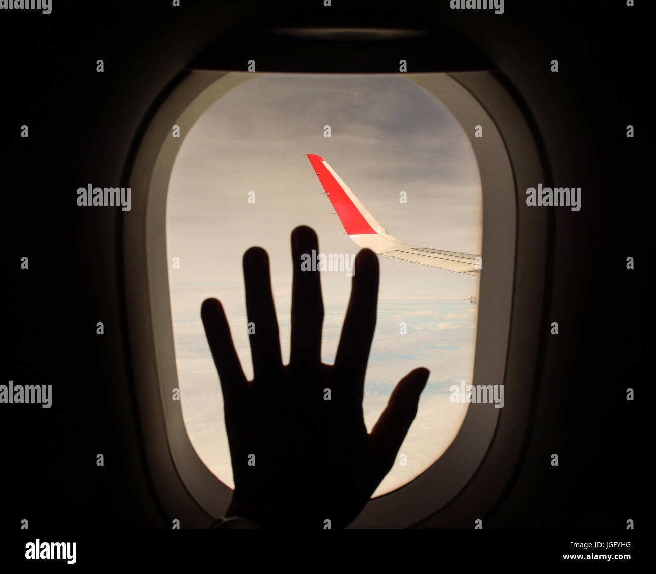 Looking through window aircraft during flight, with a hand Stock Photo ...