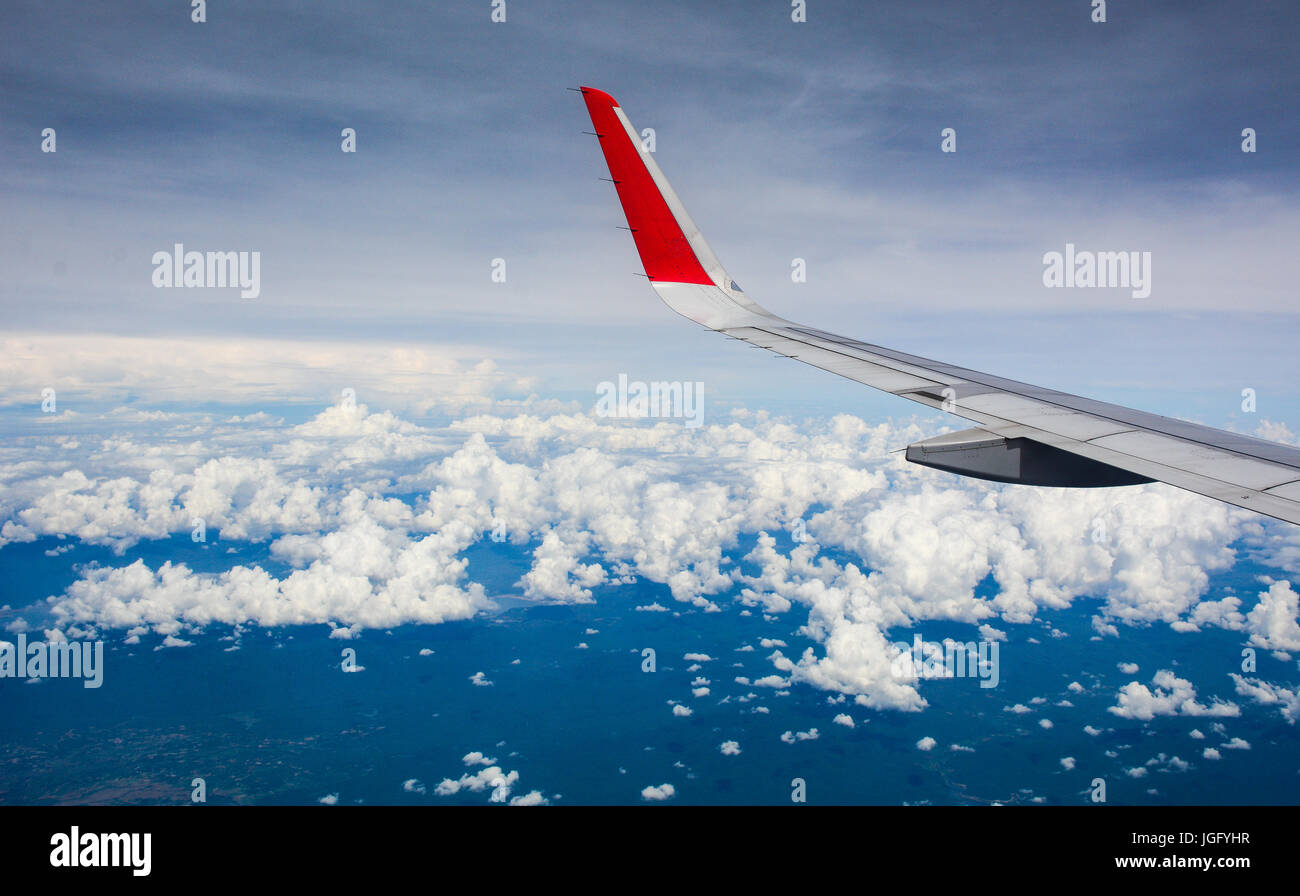 Looking through window aircraft during flight. Flying over the blue sky ...
