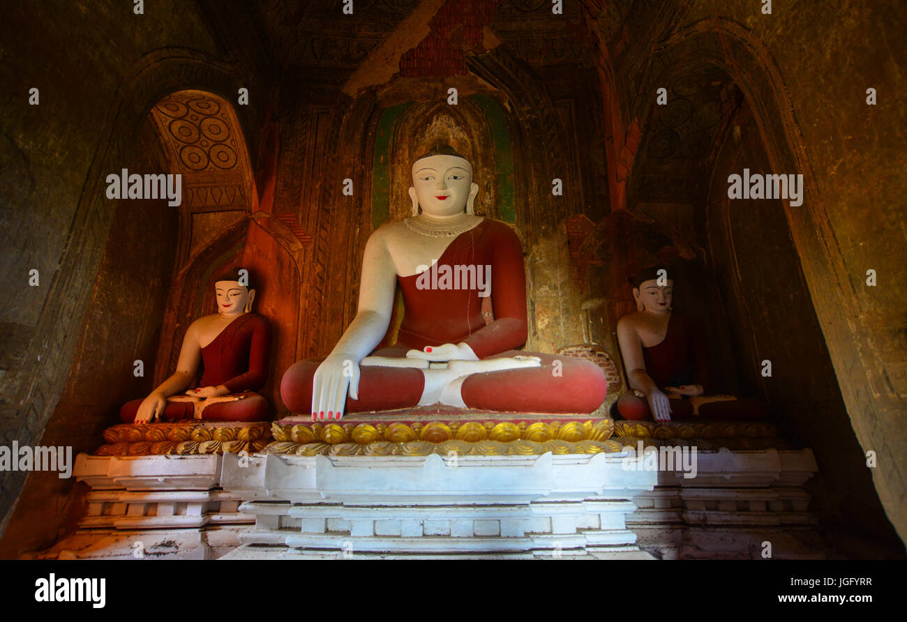 Statues at ancient Buddhist temple in Bagan, Myanmar. Bagan is one of ...