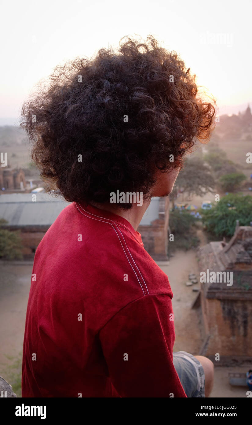 A man looking at Buddhist temples in Bagan, Myanmar. Bagan is an ...