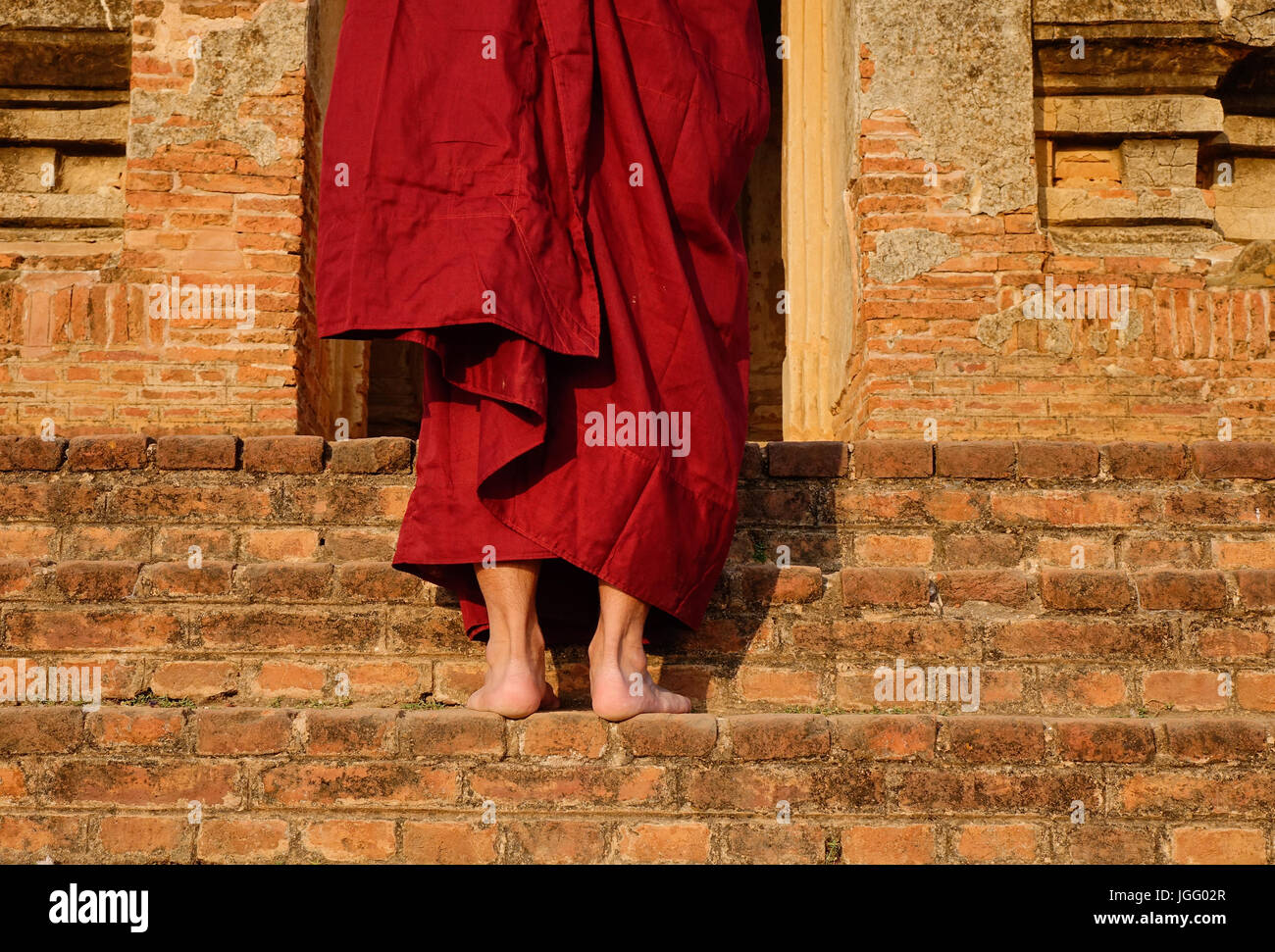 A Buddhist monk standing at the temple in Bagan, Myanmar. Bagan is an ...