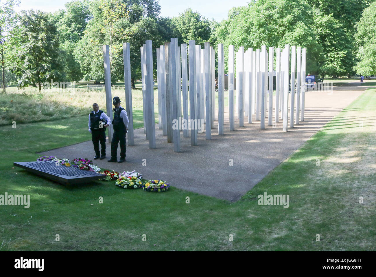 London, UK. 7th July, 2017. Police officers view the floral tributes at ...