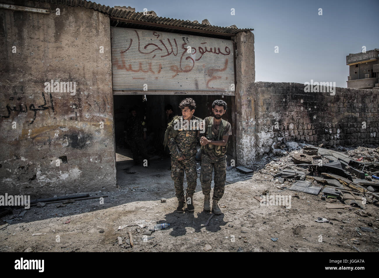 An injured soldier of the Syrian Democratic Forces (SDF) gets medical ...