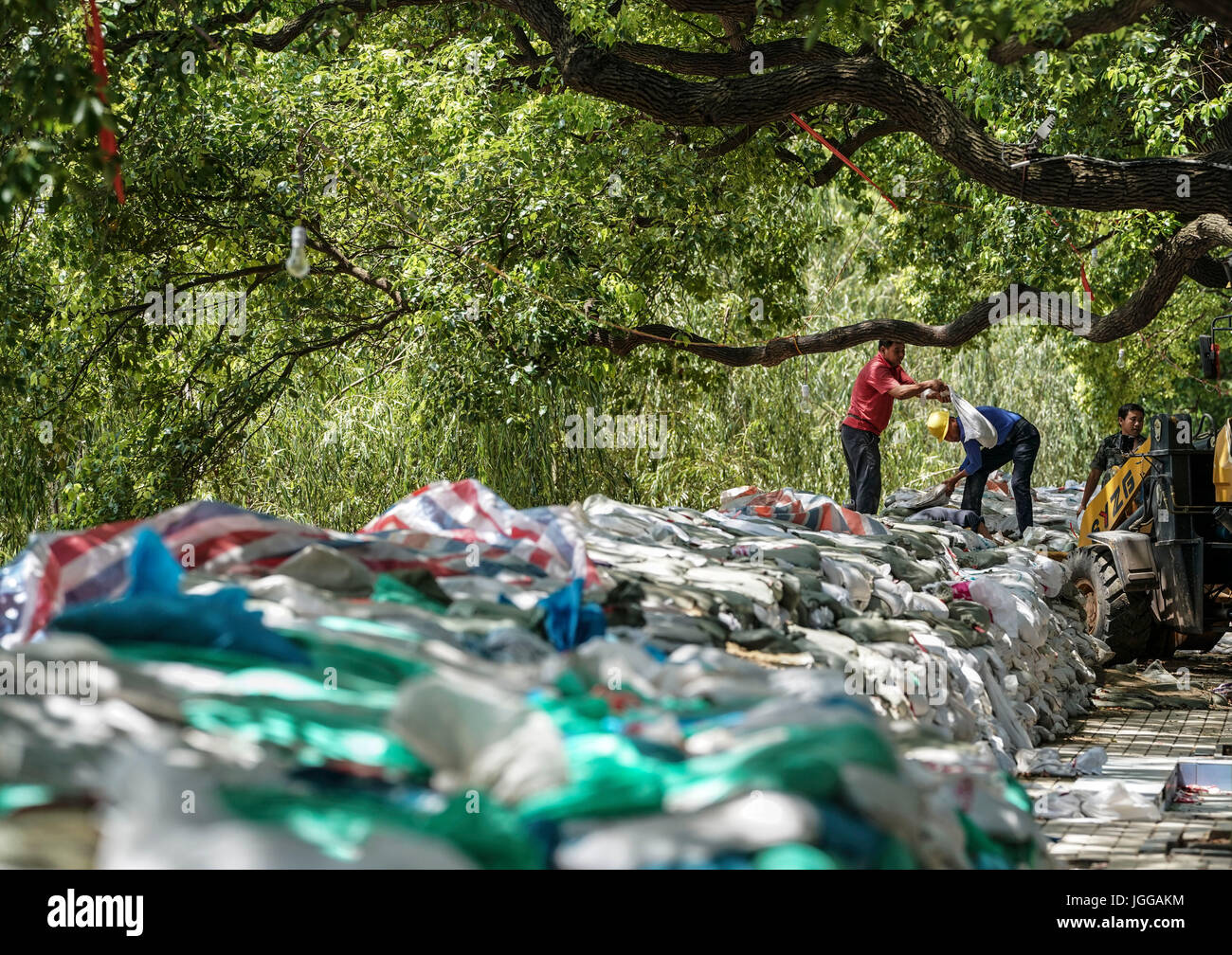 Changsha, China's Hunan Province. 7th July, 2017. Workers tear off ...