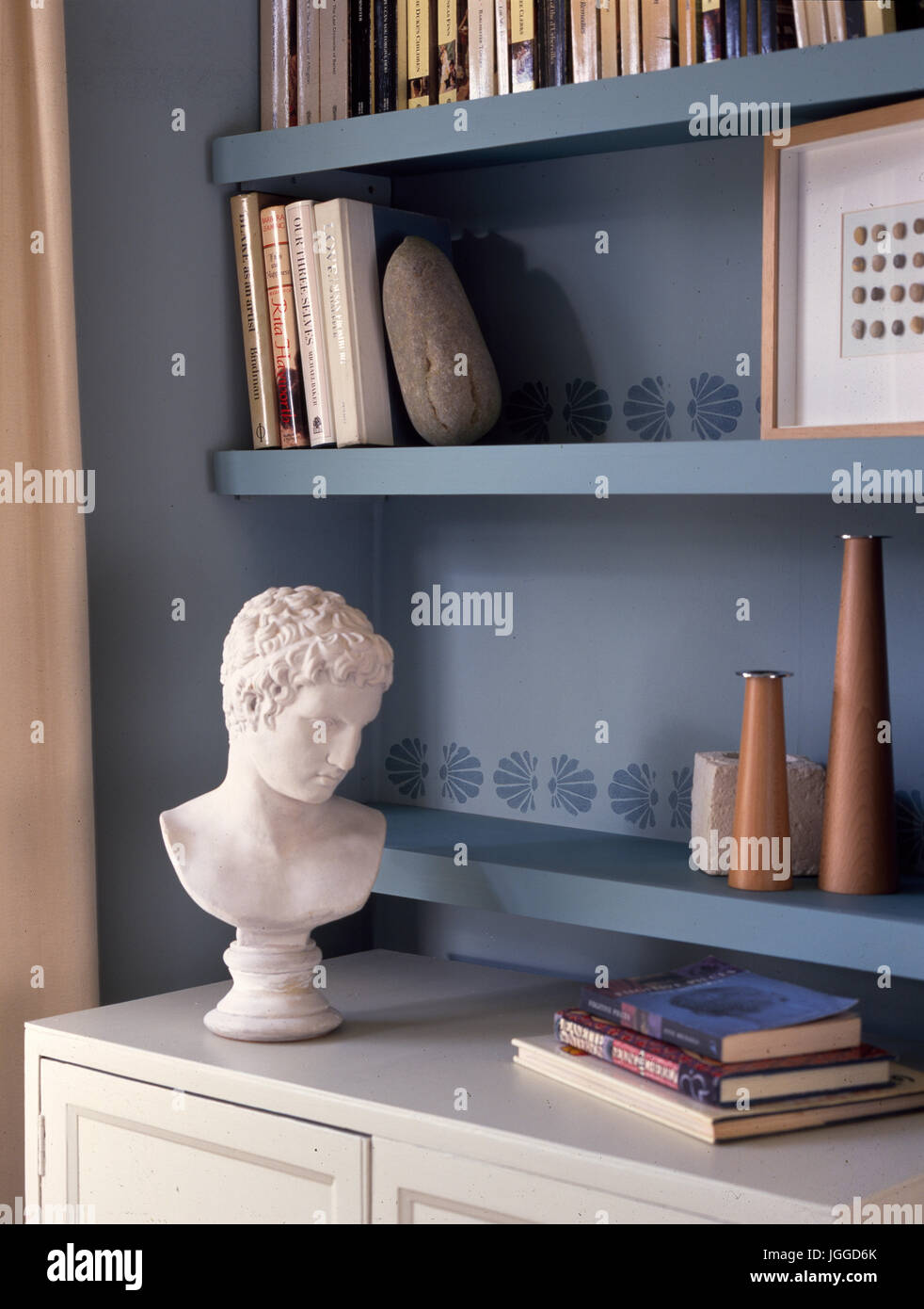 Classical bust on blue book shelves Stock Photo - Alamy