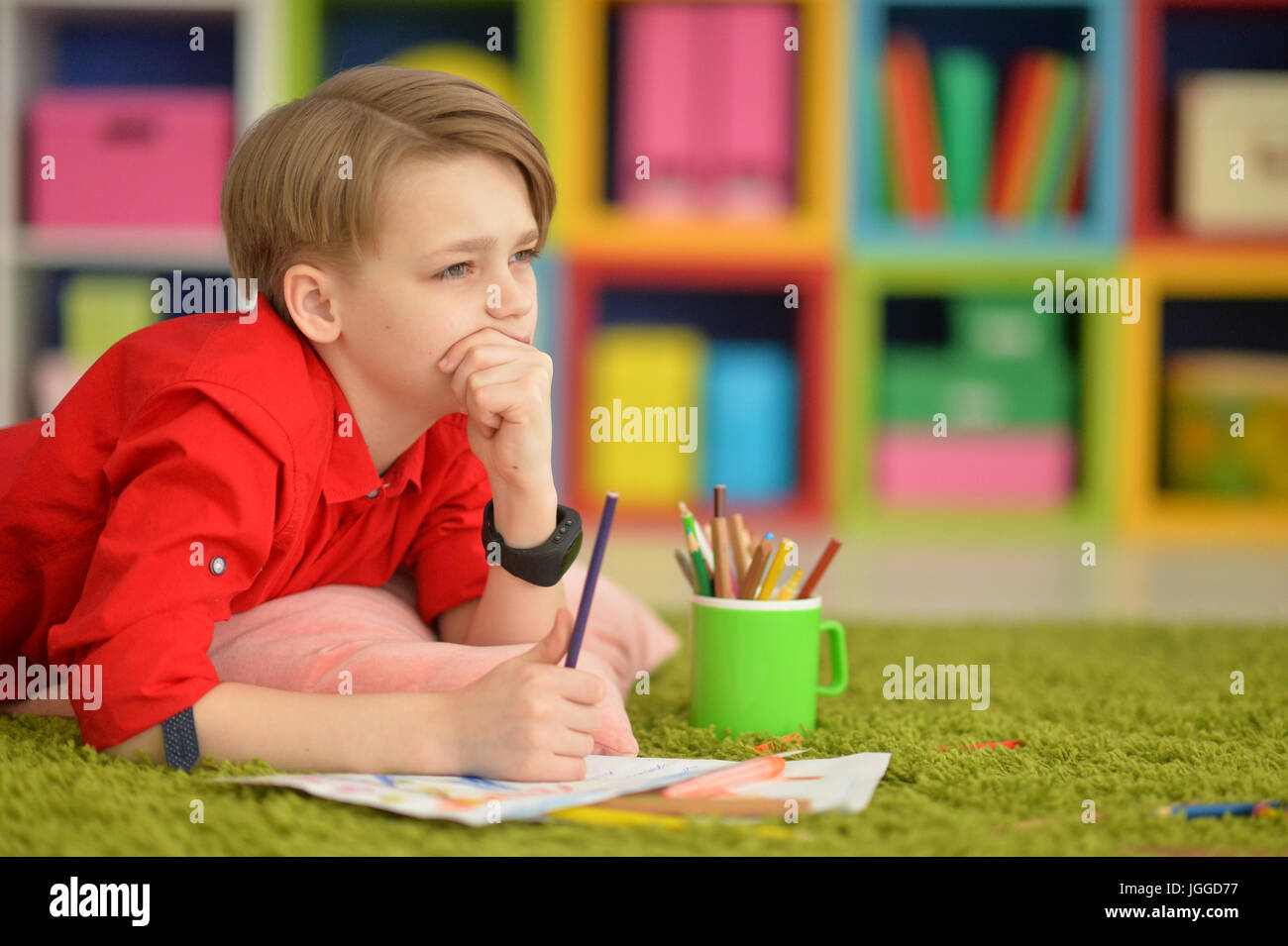 Cute boy drawing with pencils Stock Photo - Alamy