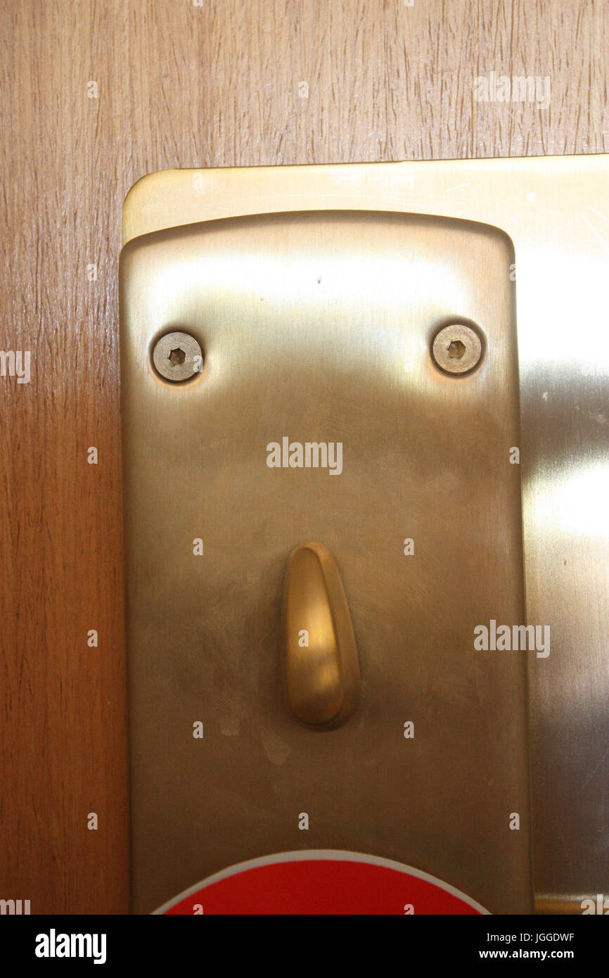 An unhappy door handle in a hotel room where the screws are the small ...