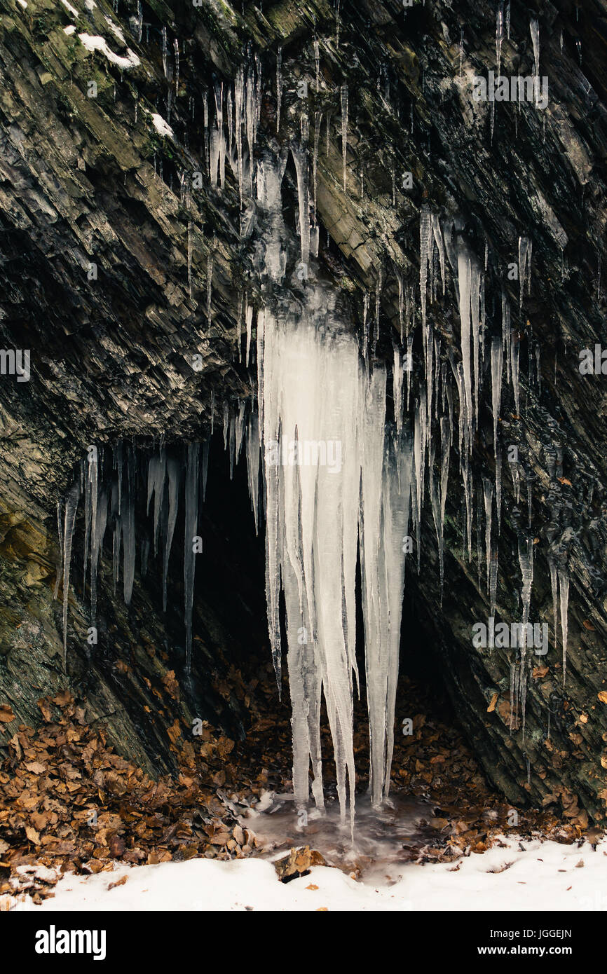 Frozen icicles hanging from a rock Stock Photo - Alamy