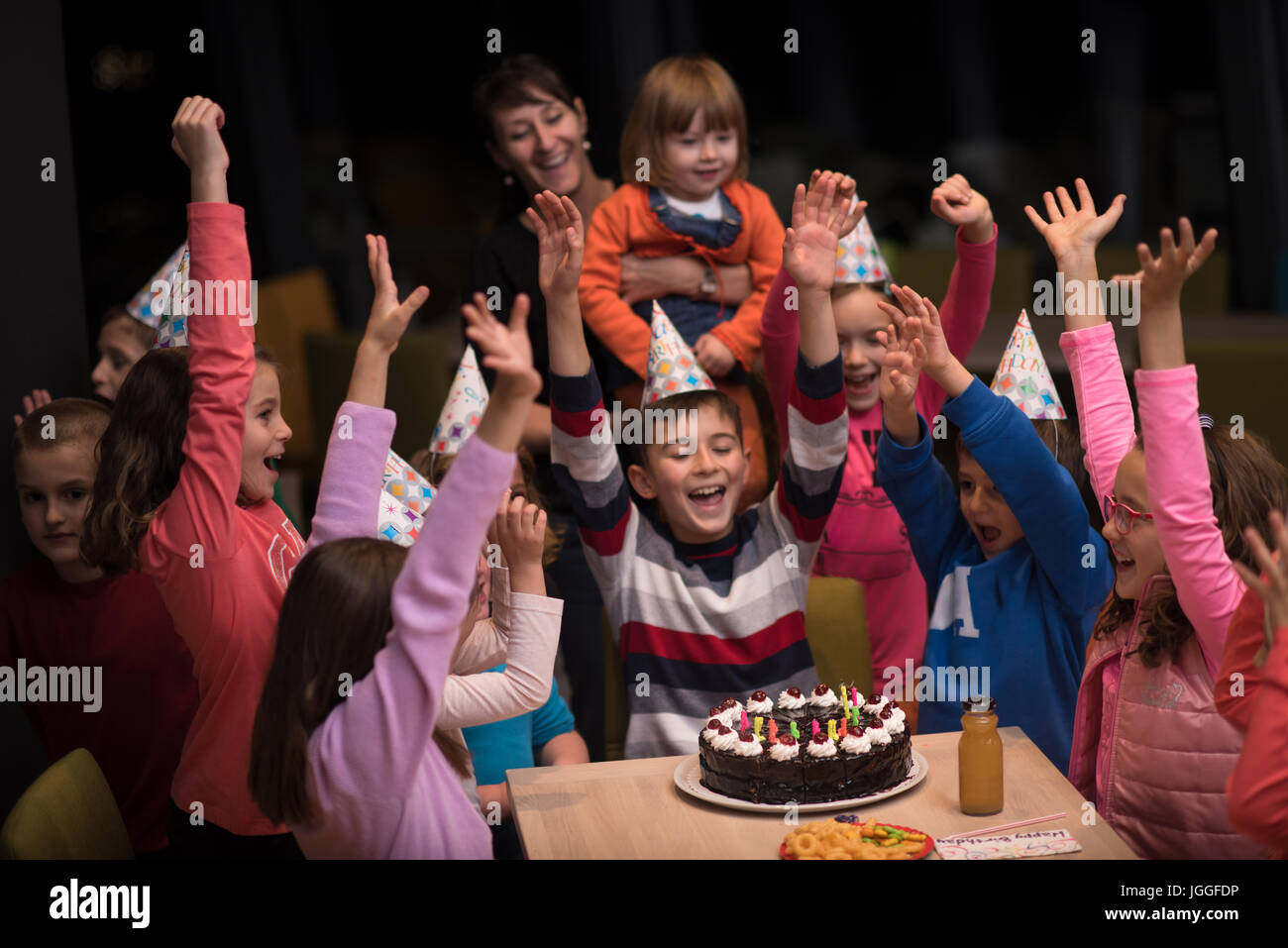 The young boy joyfully celebrating his birthday with a group of his ...