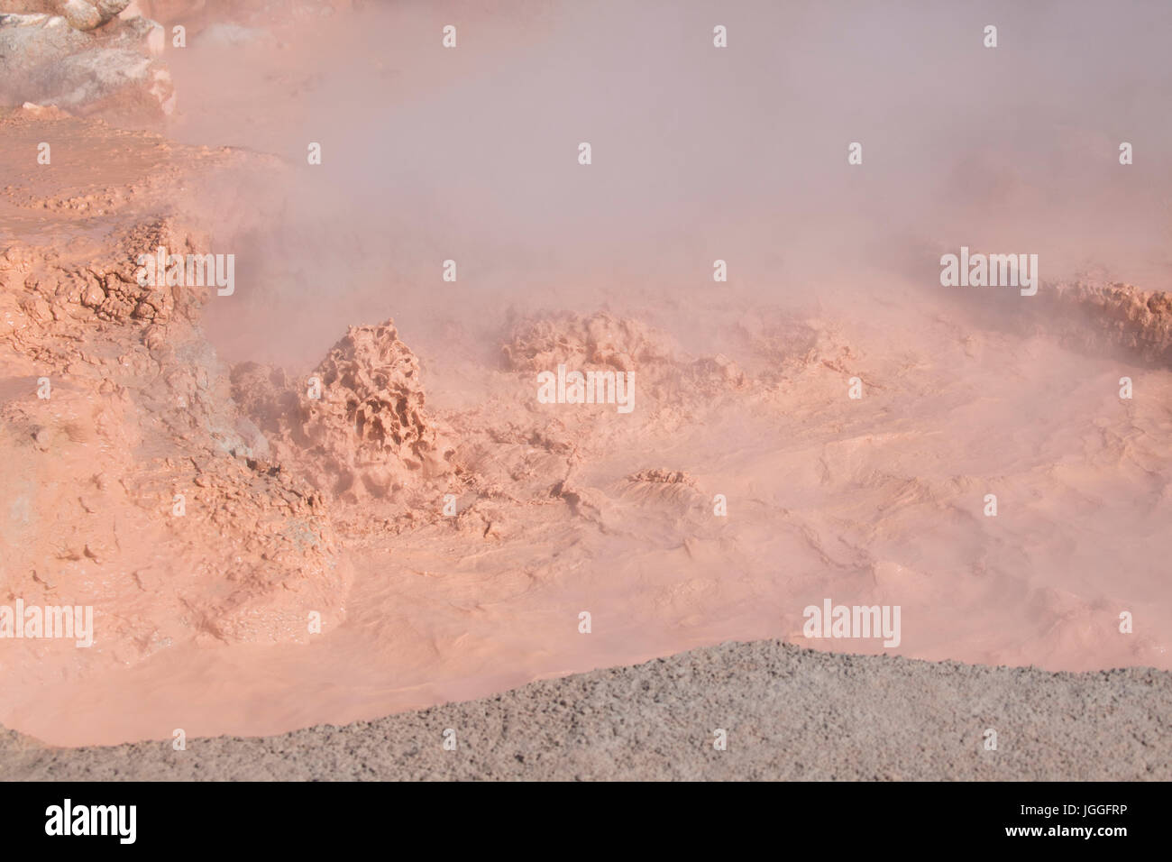 Bubbling mud pots with rust colored water in hot springs of Yellowstone ...