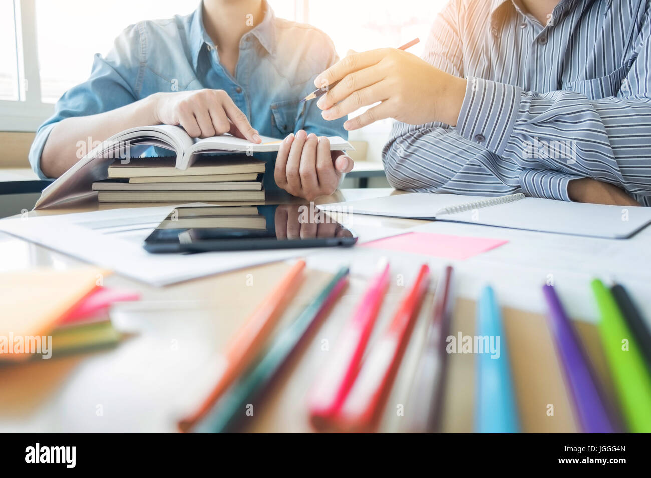 Young students campus helps friend catching up and learning tutoring ...