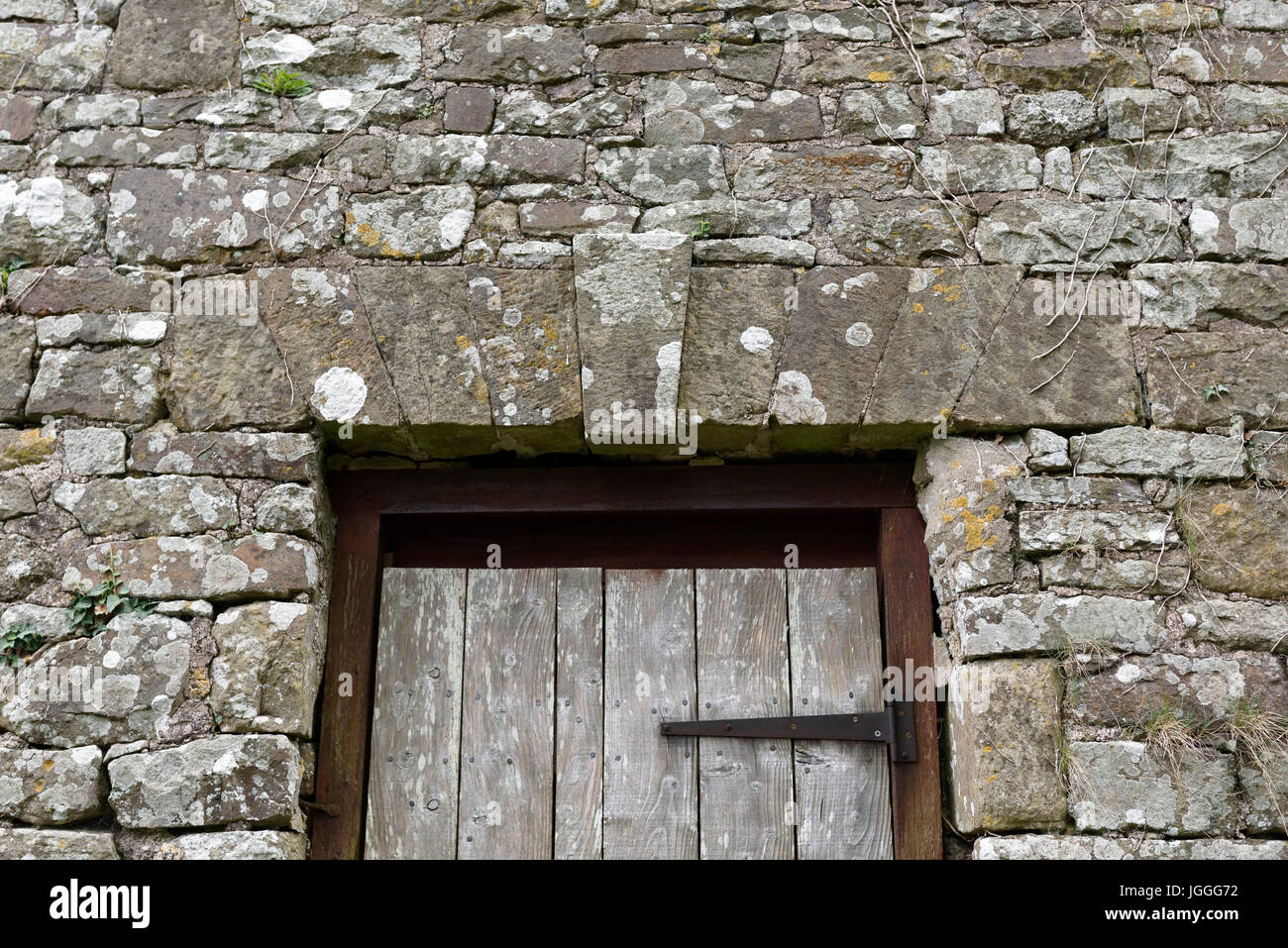 Stone out building, rubble wall and keystone and timber door in north ...