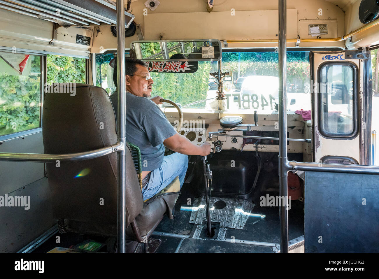 A bus driver driving public bus in Antigua City, Guatemala Stock Photo ...