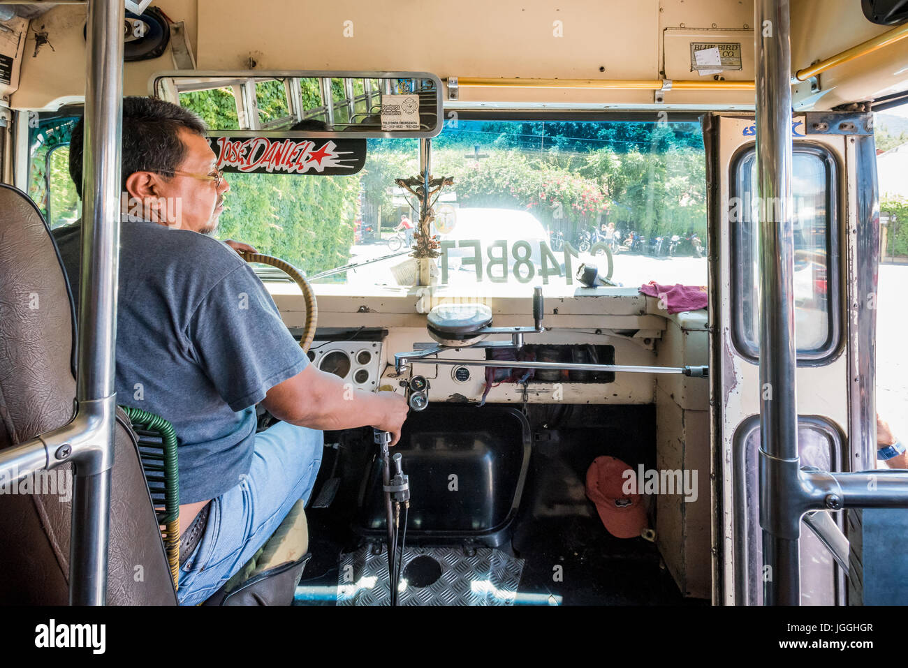 A bus driver driving public bus in Antigua City, Guatemala Stock Photo ...